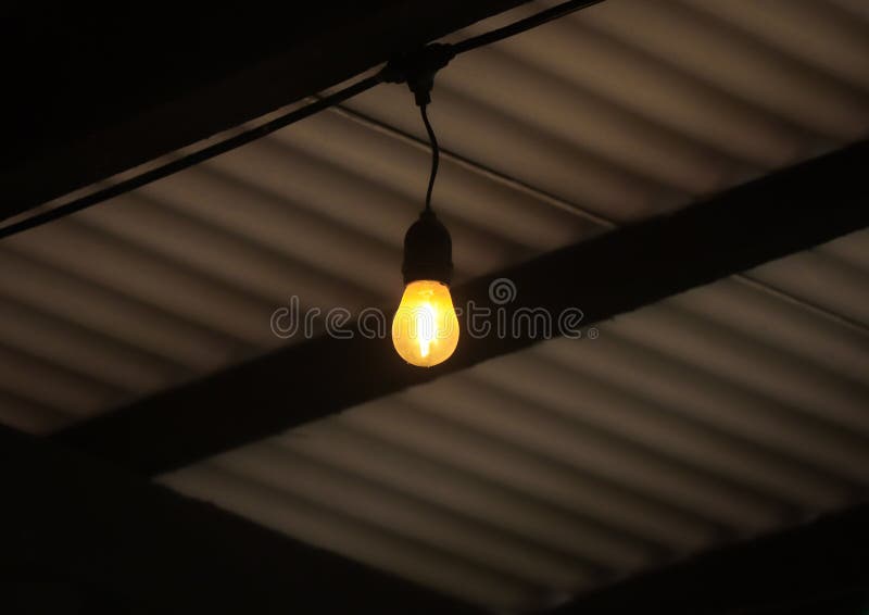 The Dim Yellow Bulb Lamp Hanging from the Ceiling Stock Image - Image ...