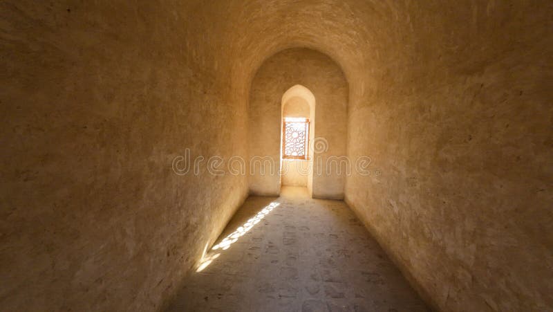 Dimly Lit Corridor with Arched Ceiling and Ornate Window Stock Image ...