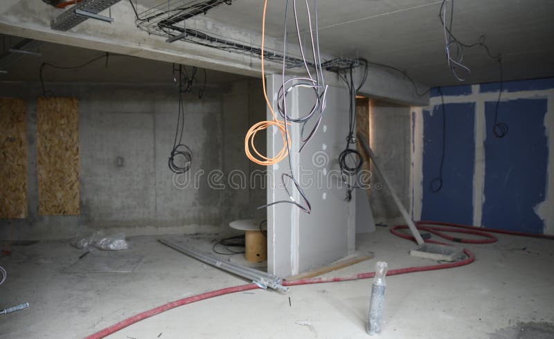 Dimly Lit Interior Under Construction, with Exposed Concrete Walls and ...