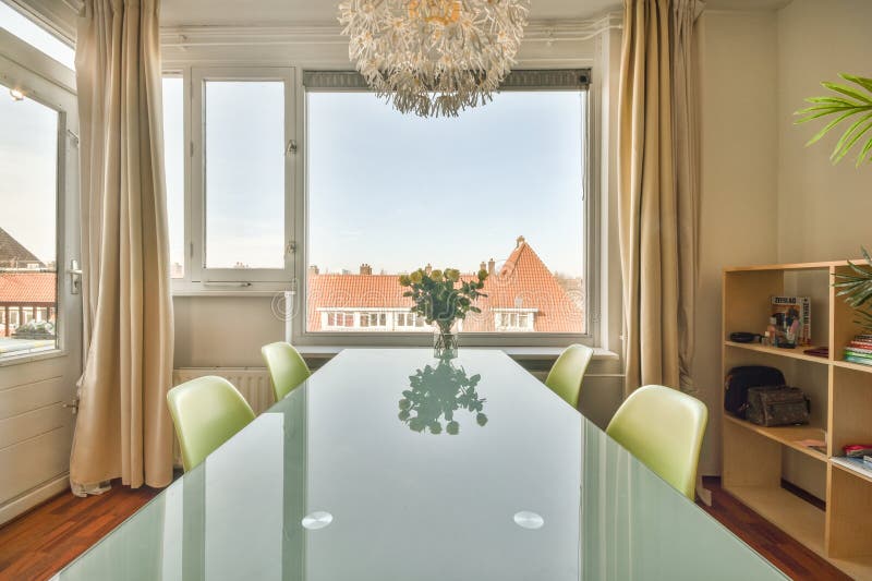 A Dining Room with a Glass Table and a Window Editorial Photography ...