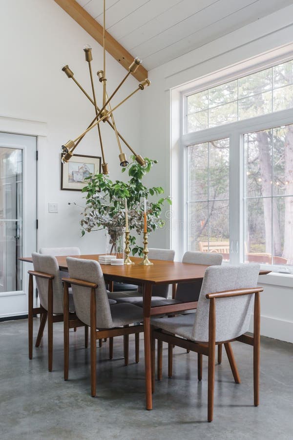 Dining Room Interior Featuring a Wooden Table with Several Chairs Set ...