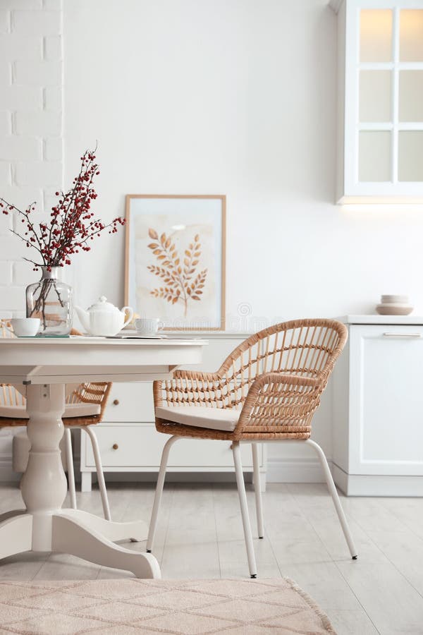Dining Room Interior with Tea Set on Round Table and Wicker Chairs ...