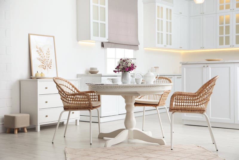 Dining Room Interior with Tea Set on Round Table and Wicker Chairs ...