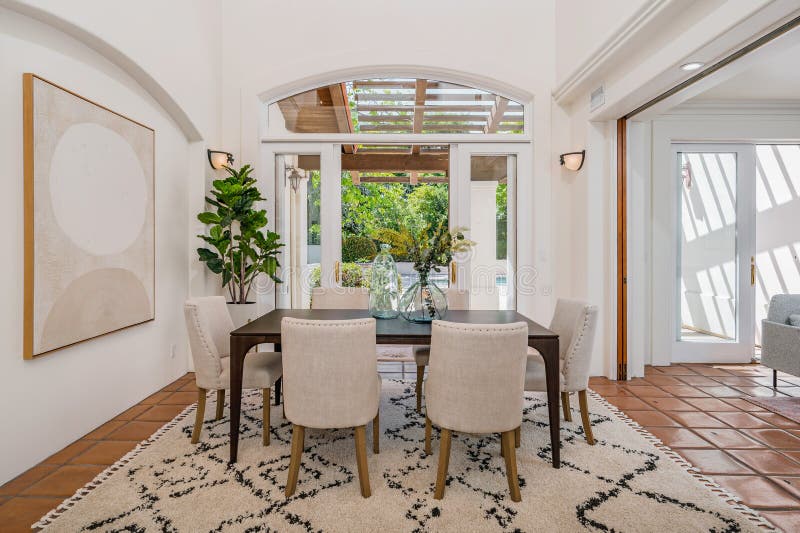 There is a Dinning Room with Several Chairs and Tables Stock Image ...