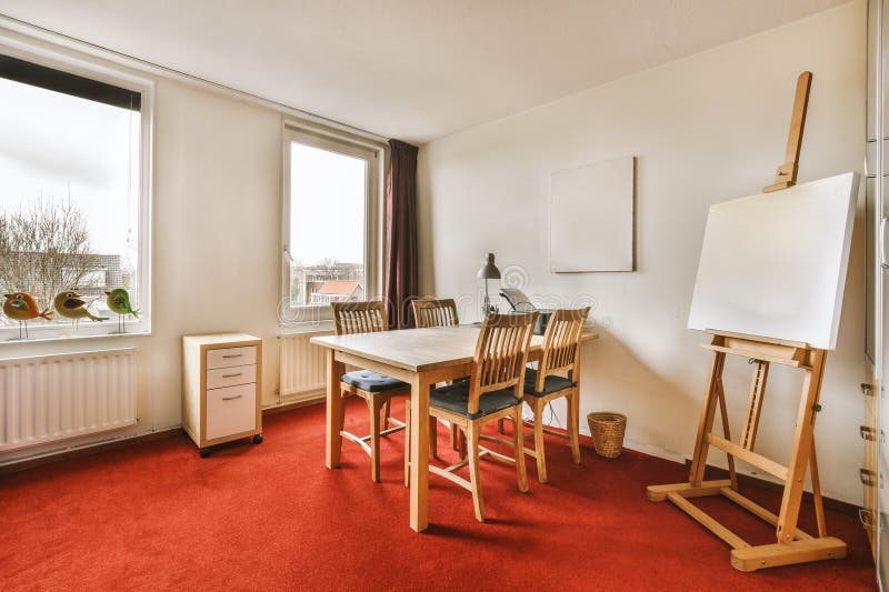 A Dining Room with a Table and a Easel Stock Photo - Image of living ...