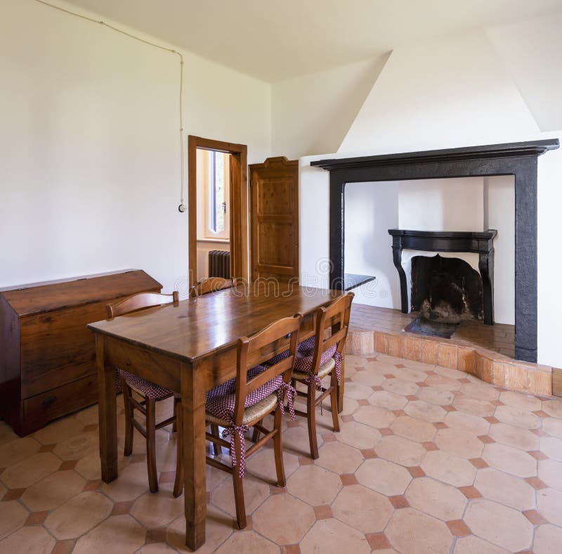Dining Room with Table, Wooden Chairs and a Stone Fireplace Stock Photo ...