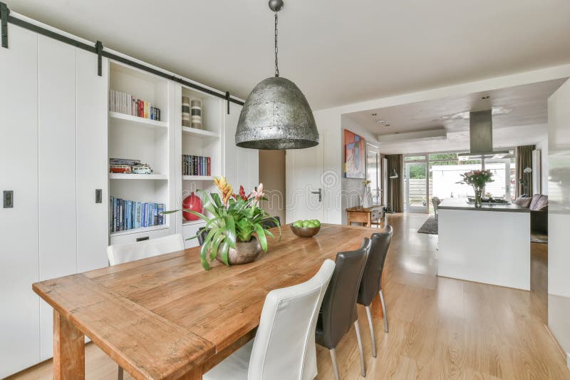 A Dining Room with a Wooden Table and White Chairs Editorial ...