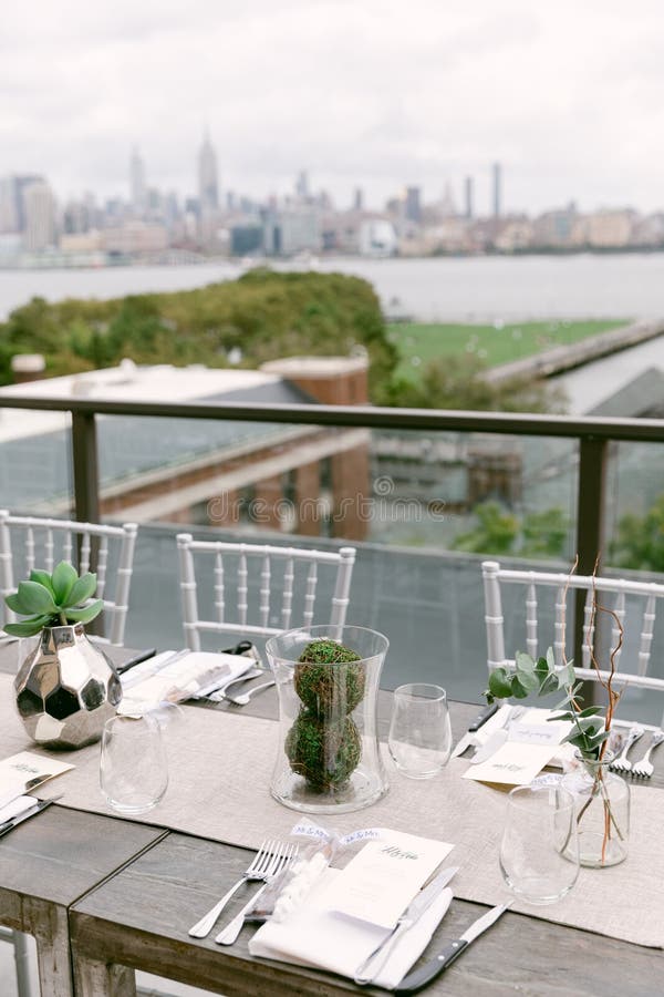 Dining Setup with a City Skyline View at a Rooftop Venue during a ...