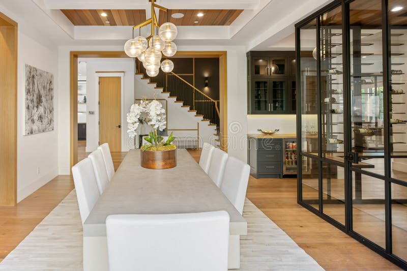 A Dining Table and Chairs are Near a Spiral Staircase Case Stock Photo ...
