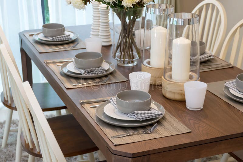 Dining Table and Comfortable Chairs with Elegant Table Setting Stock ...