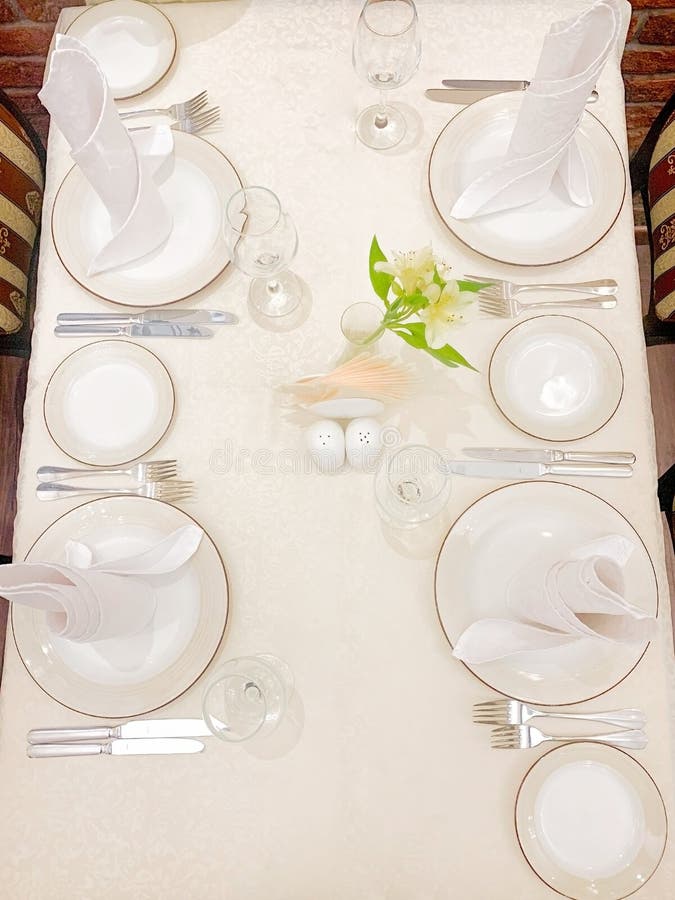 The Dining Table is Covered with a White Tablecloth, There are ...