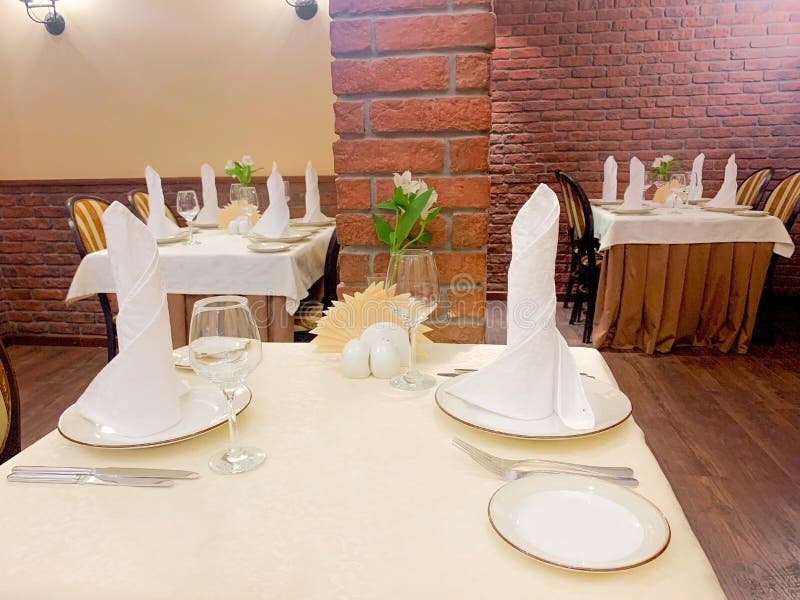 The Dining Table is Covered with a White Tablecloth, There are ...