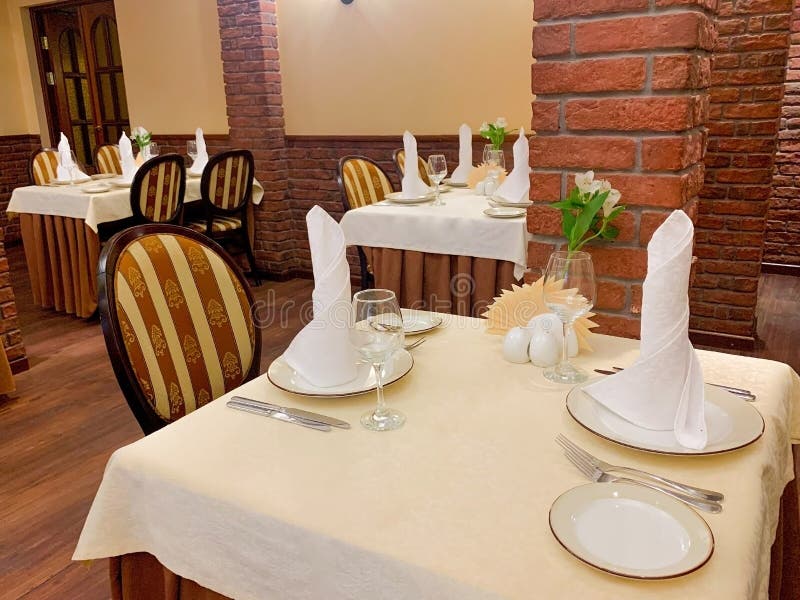 The Dining Table is Covered with a White Tablecloth, There are ...