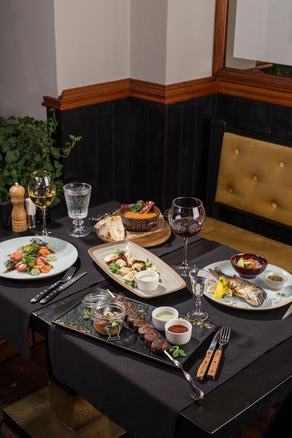 Dining Table Food Set with Appetizer and Drinks in Restaurant Stock ...