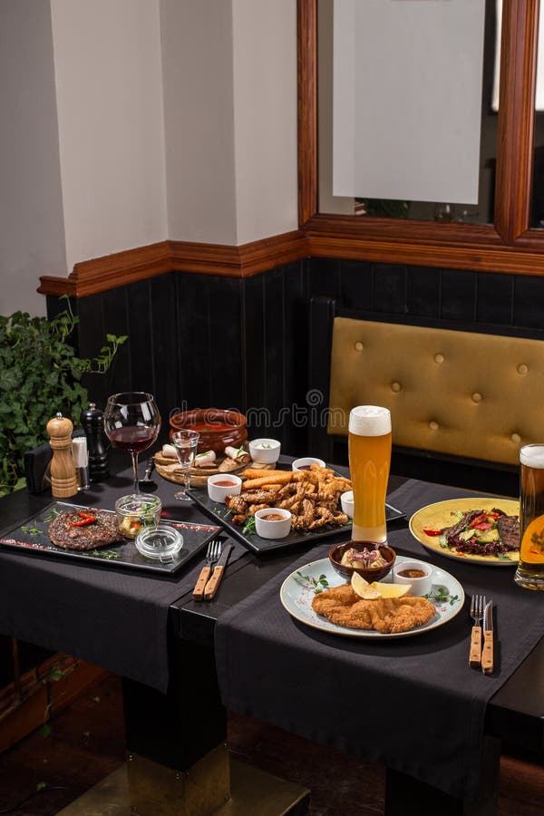 Dining Table Food Set with Beer Appetizer and Drinks in Restaurant ...