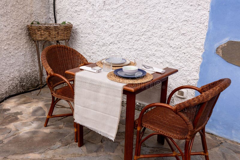 Dining Table Set in a Cafe with Rattan Chairs Outdoors Stock Photo ...