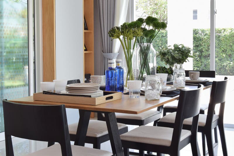 Dining Wooden Table and Comfortable Chairs in Modern Home Stock Image ...