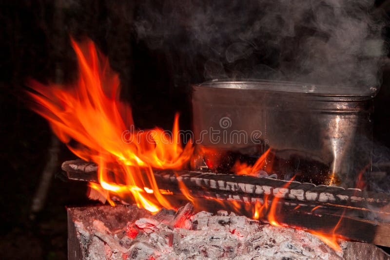 Dinner at the Camping. Kettle on a Burning Fire, Fire, Smoke. Preparing ...