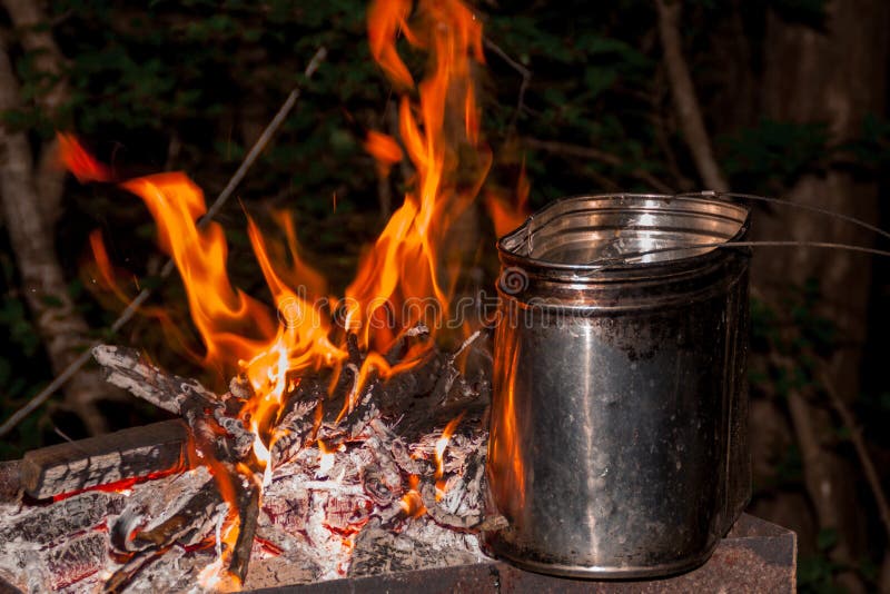 Dinner at the Camping. Kettle on a Burning Fire, Fire, Smoke. Preparing ...