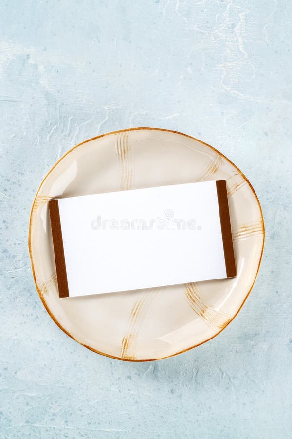 Dinner Invitation. a Card on a Ceramic Plate with a Gold Rim, Top Shot ...