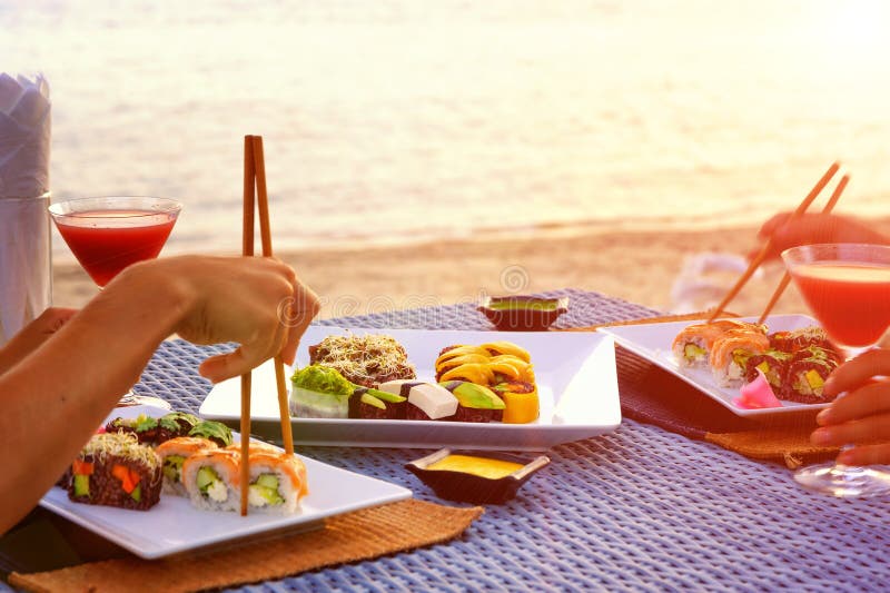 The Dinner with Japanese Sushi at the Beach on the Sunset Stock Photo ...