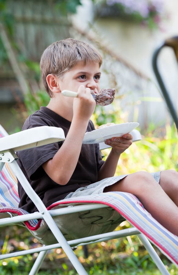 Little boy eating pudding stock image. Image of garden - 16870947