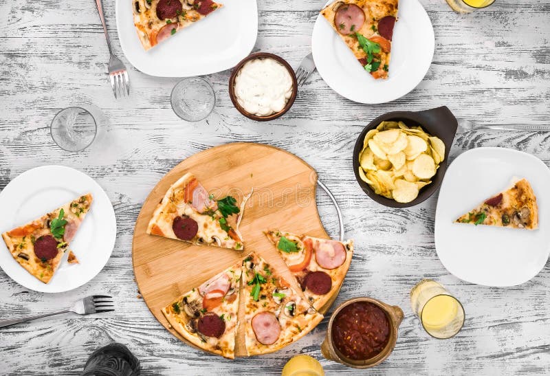 Dinner with Pieces of Pizza on Board and Plates Stock Image - Image of ...