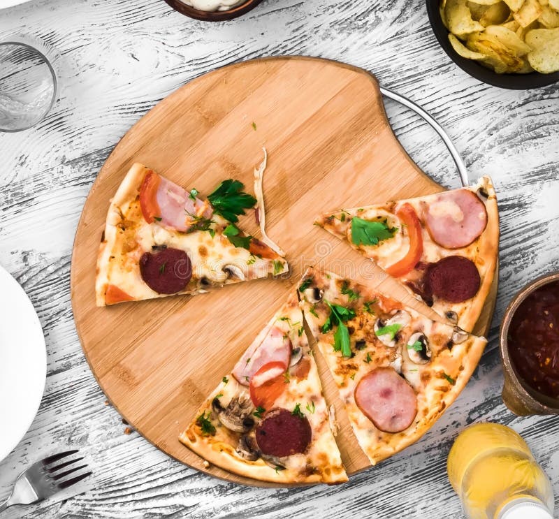Dinner with Pieces of Pizza on Board and Plates Stock Photo - Image of ...