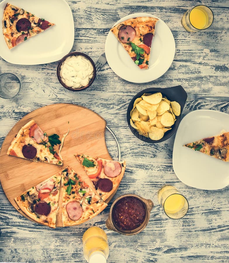 Dinner with Pieces of Pizza on Board and Plates Stock Image - Image of ...