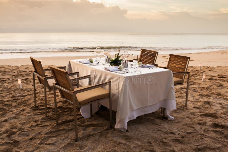Dinner table on the beach. stock photo. Image of bouquet - 180367120