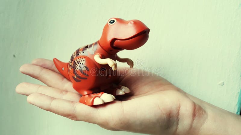 Dinosaur in hand stock photo. Image of dinosaur, object - 139153790