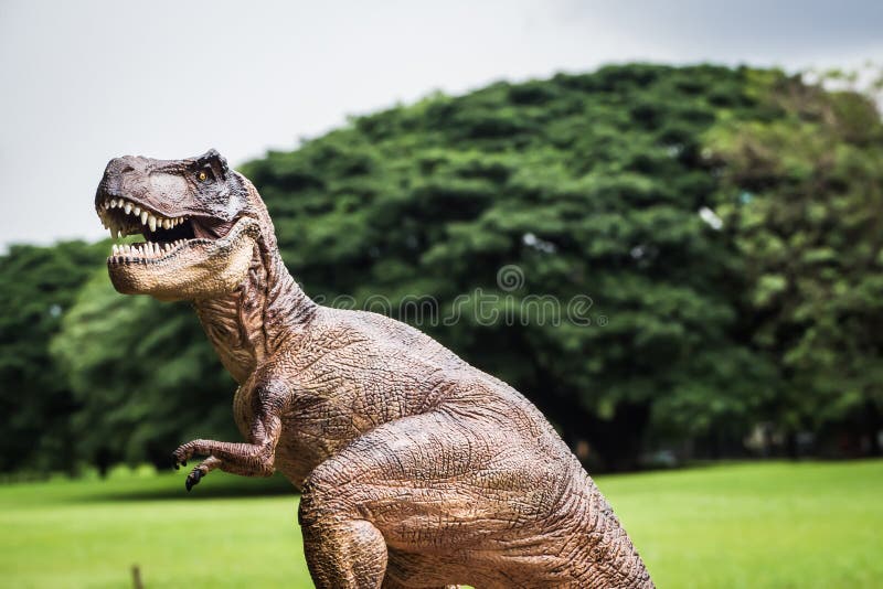 Dinosaur , T-rex with Tree Branches Against on the Nature Stock Image ...