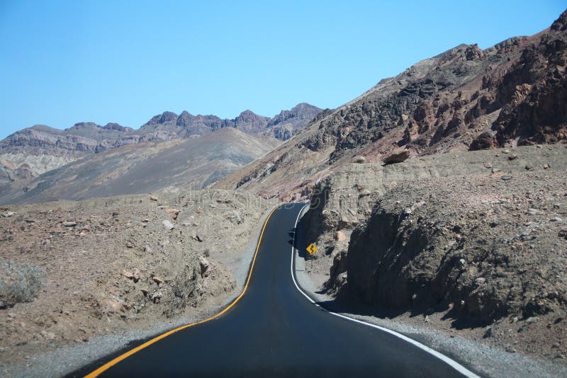 The Dip in the Black Road on the Rock Formations of the Desert Stock ...