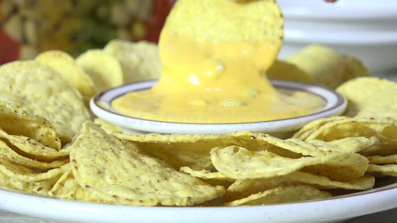 Dipping a Corn Chip into a Cheese Sauce Stock Footage - Video of ...