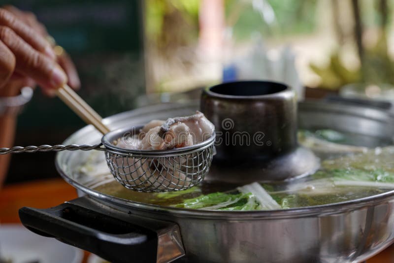 Dipping Slice of Fish in Metal Strainer into Boiled Soup. Stock Image ...