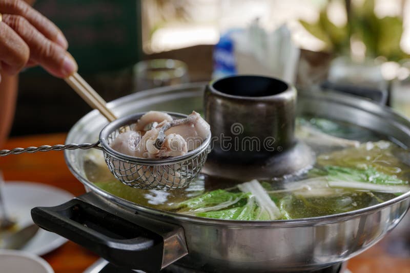 Dipping Slice of Fish in Metal Strainer into Boiled Soup. Stock Image ...