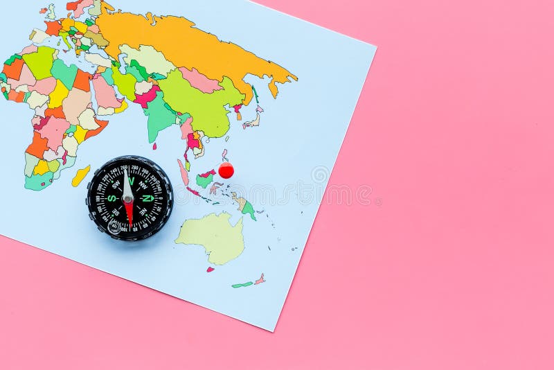 Direction Concept with Compass and Map on Pink Background Top View ...