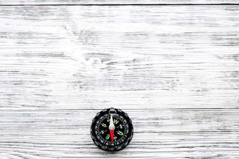 Direction of Movement. Compass on Gray Wooden Background Top View Copy ...