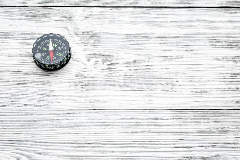 Direction and Movement Concept with Compass on White Wooden Background ...