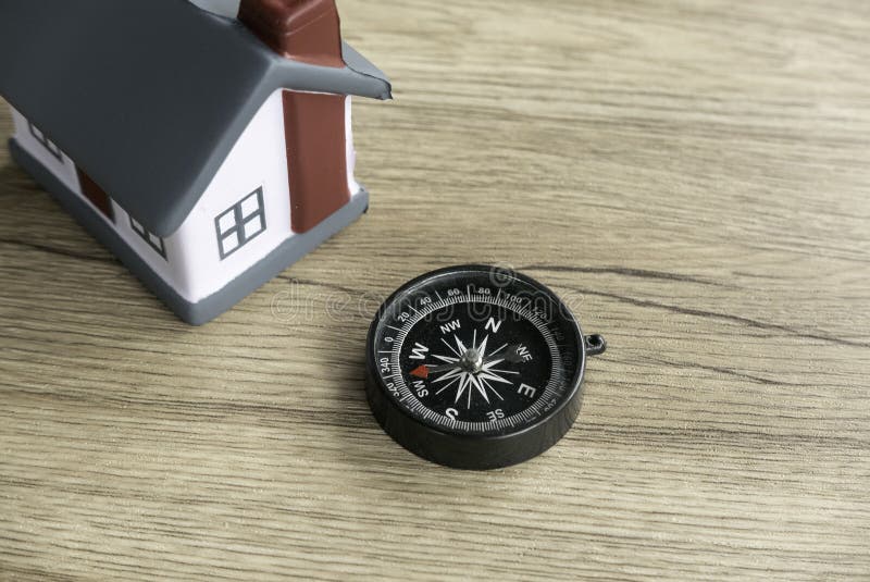 Direction in Real Estate: House Model and Compass on Wooden Table Stock ...