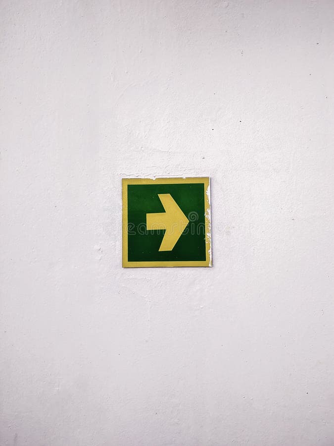 A Direction Sign Attached To the Wall Stock Image - Image of arrow ...