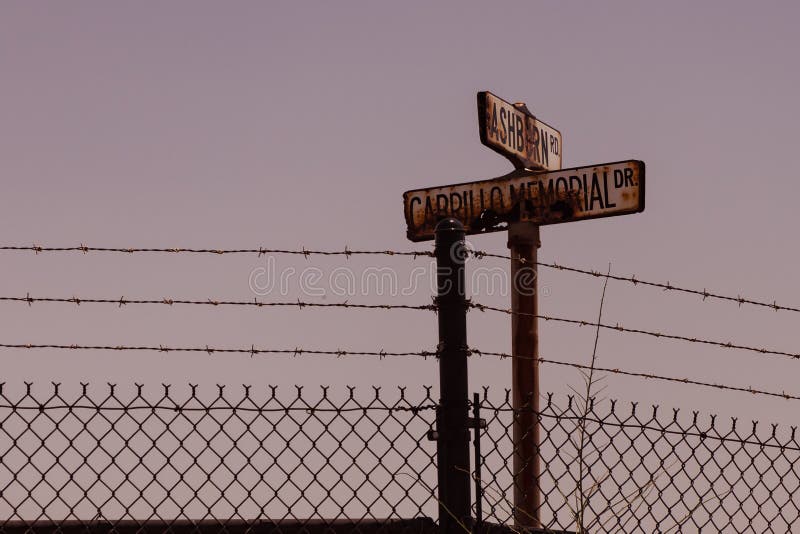 Direction Sign Behind a Barbed Wire Fence Stock Image - Image of travel ...