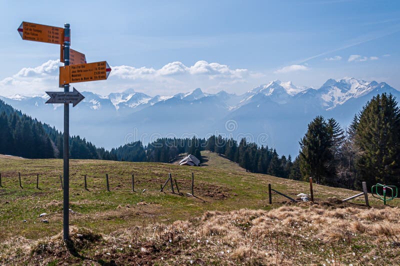 Direction Sign Post on a Hill with the Beautiful Swiss Alps in the ...