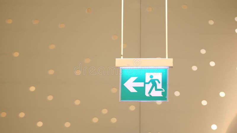 Emergency Exit Sign Points Left at a Modern Building Space Stock ...