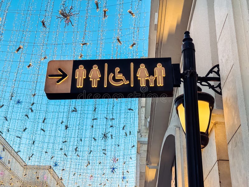 Directional Sign Indicating Restrooms and Accessibility Features in ...