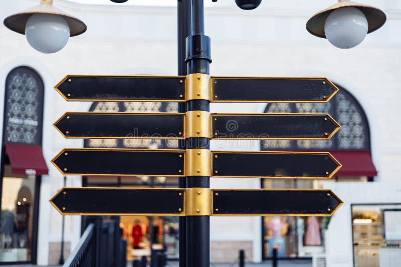Directional Signpost Stands in a Shopping District with Multiple Blank ...
