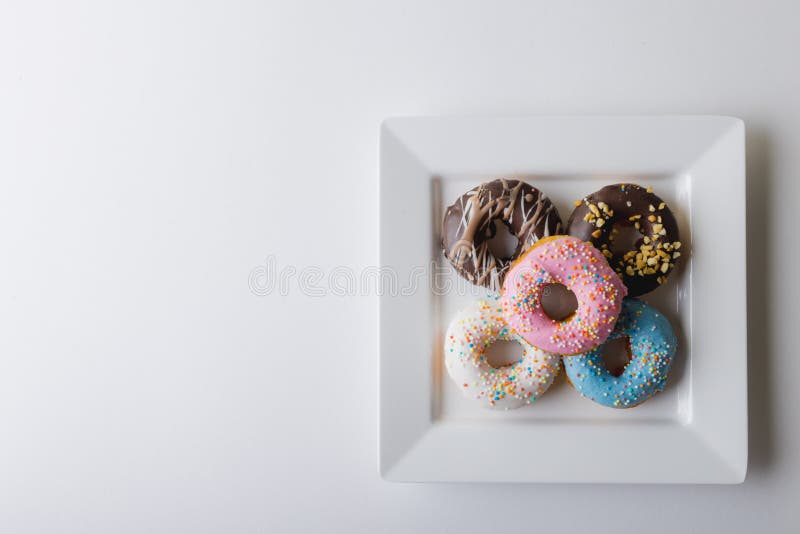 Directly Above View of Fresh Multi Colored Donuts in Square Plate by ...