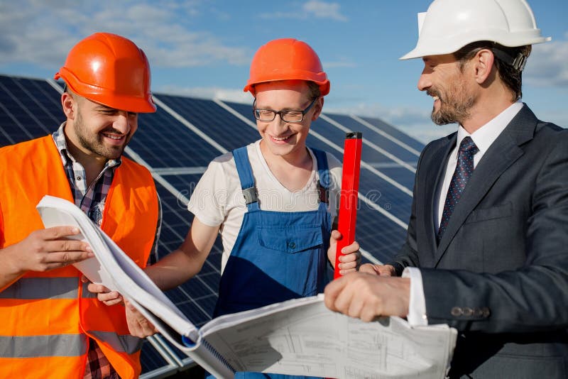 Director, Foreman and Worker Looking in Technical Drawings at Solar ...