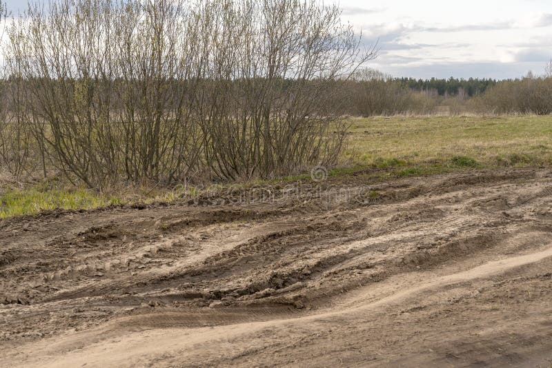 Dirt Damaged Rural Spring Road in a Field. Concept of Problem with the ...