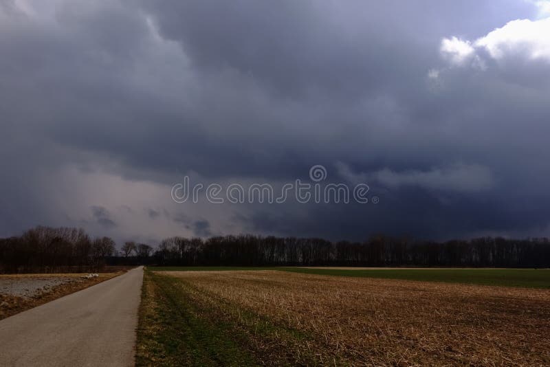 Dirt Road with Fields and Dark Rain Clouds Stock Photo - Image of black ...